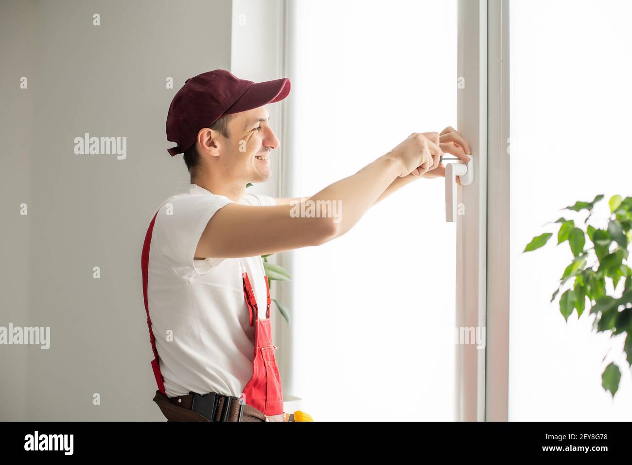 Construction worker installing window in house Stock Photo - Alamy