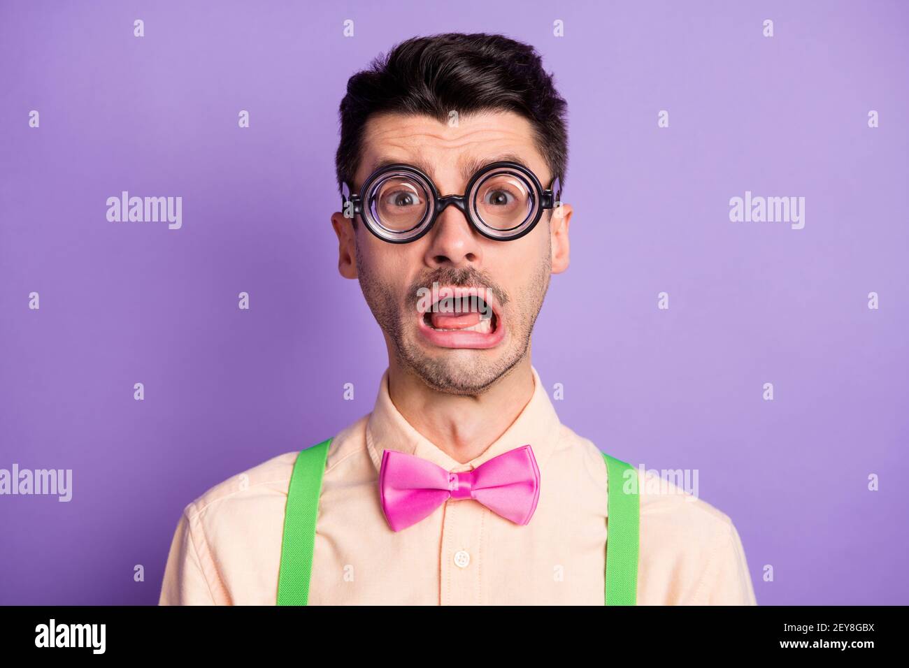 Photo of scared nerd man wear glasses green suspenders pink bow tie ...