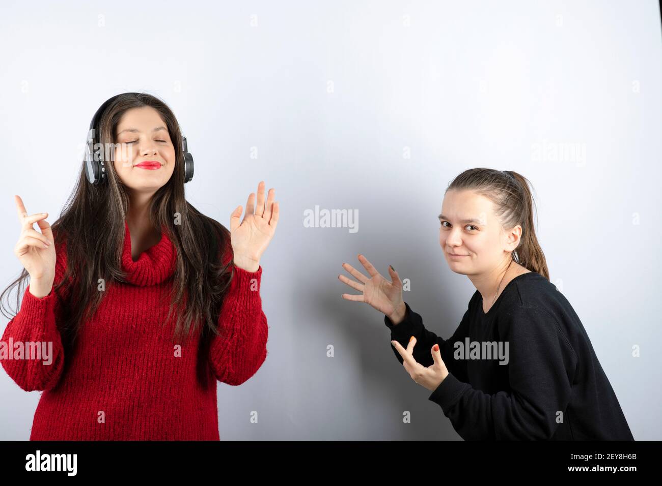 Young girl looking at camera angrily while brunette woman listening ...