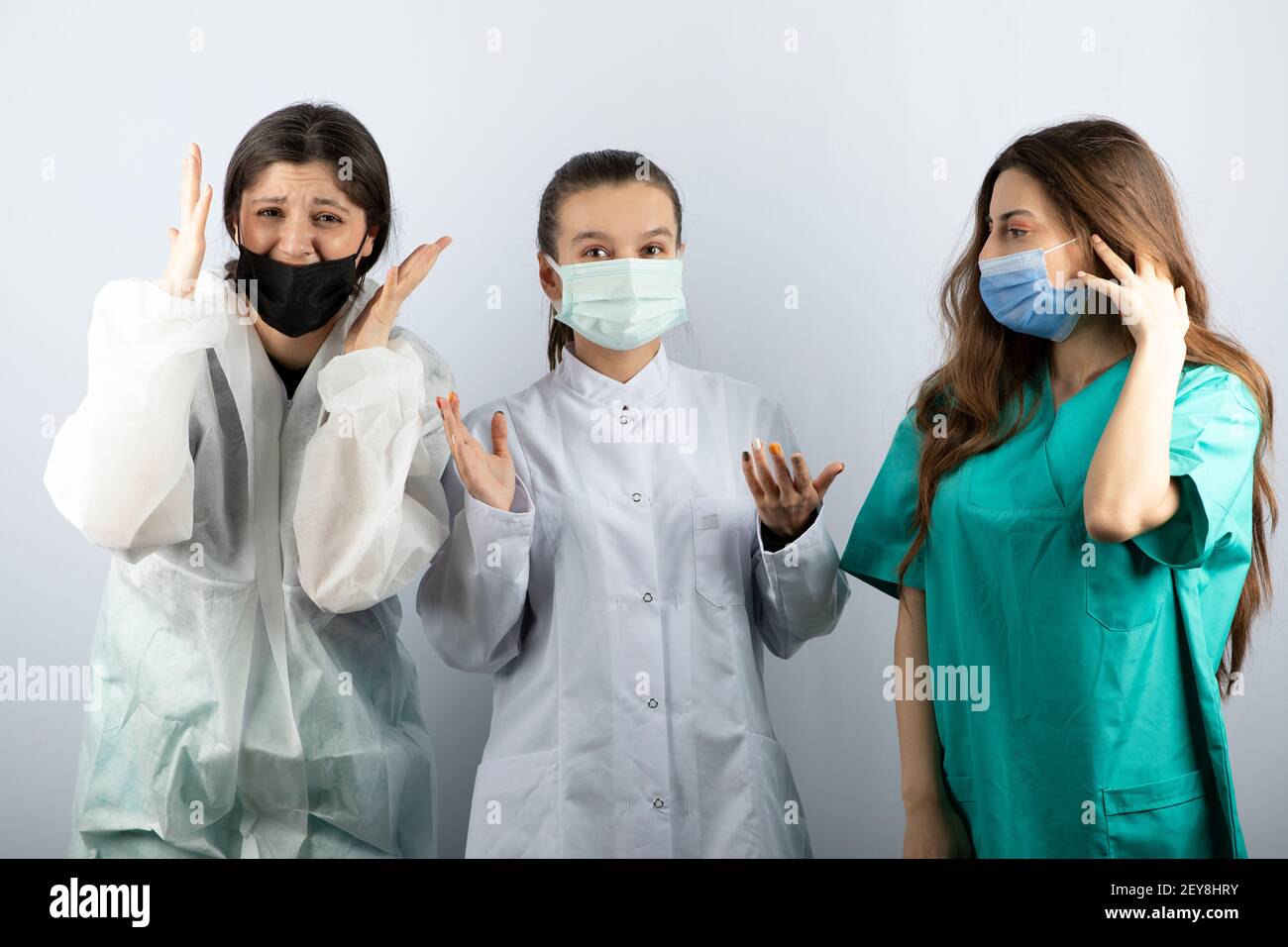 Three young female doctors standing and looking at camera Stock Photo ...