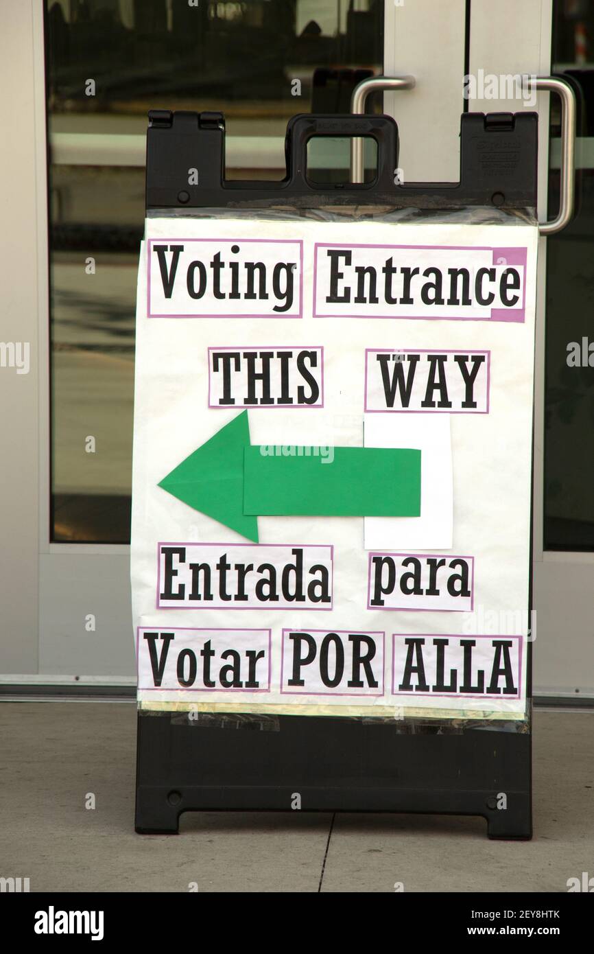 A bilingual English/Spanish sign points the way to a California polling ...