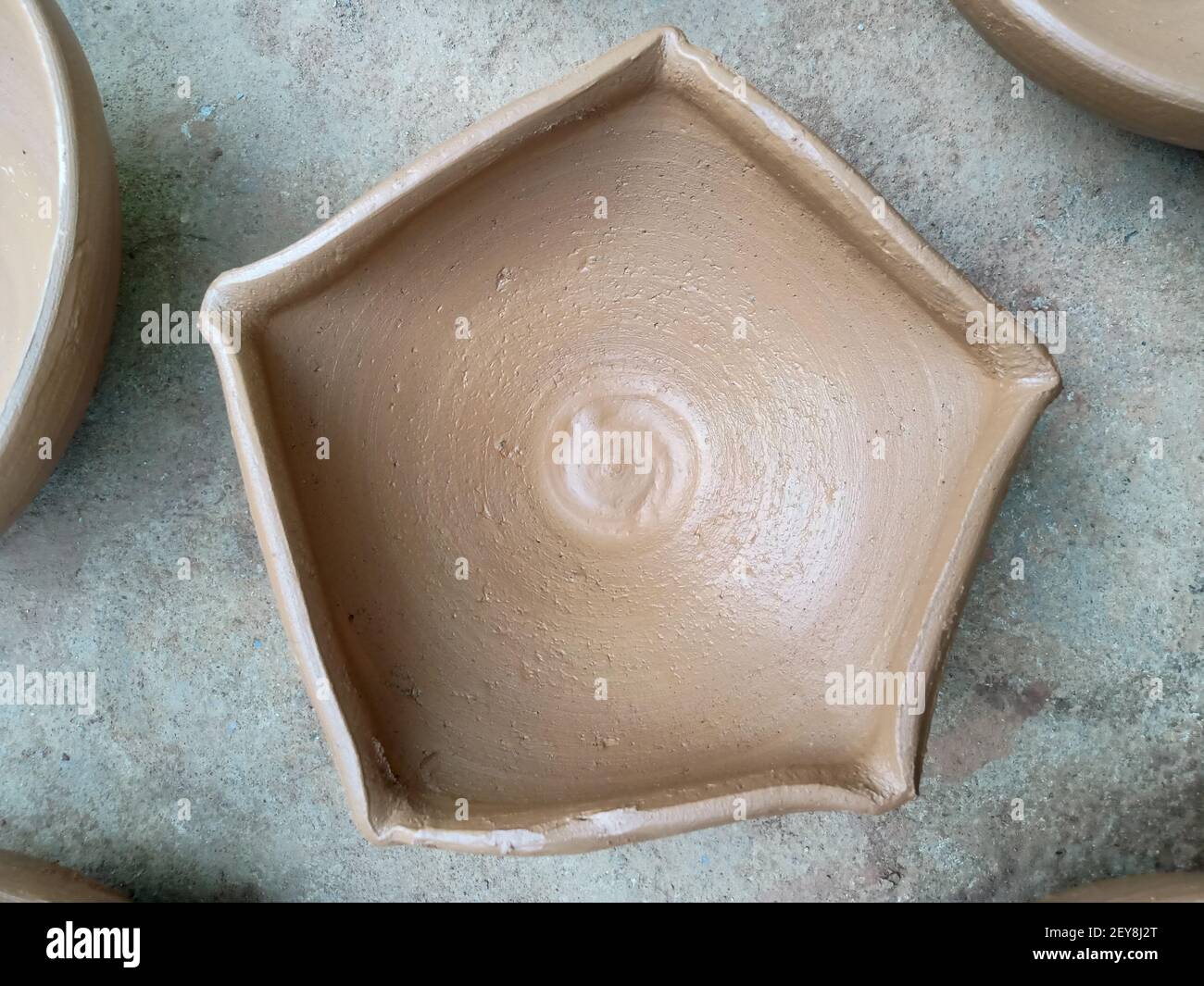 A top view of shallow pentagon shaped clay pot Stock Photo - Alamy