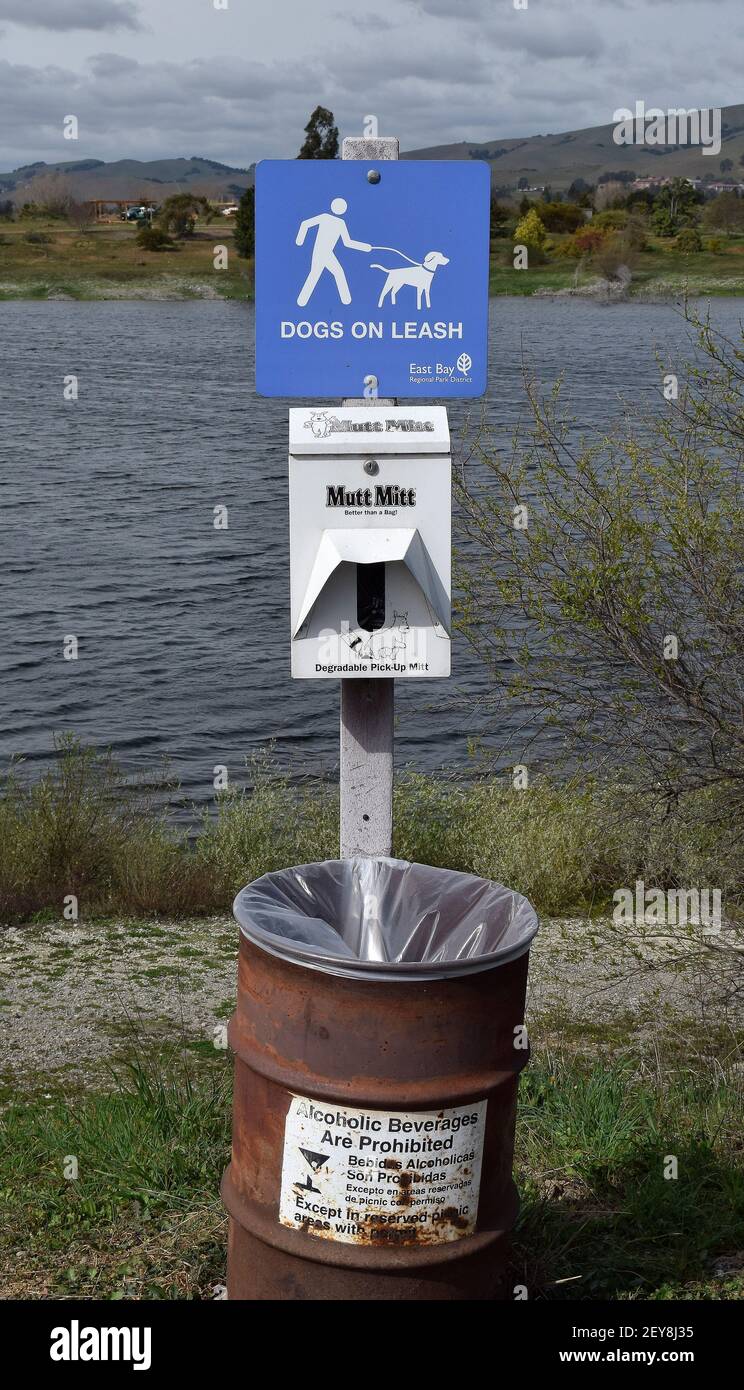 dog on leash sign and Mutt Mitt degradable pick-up mitt dispenser at ...