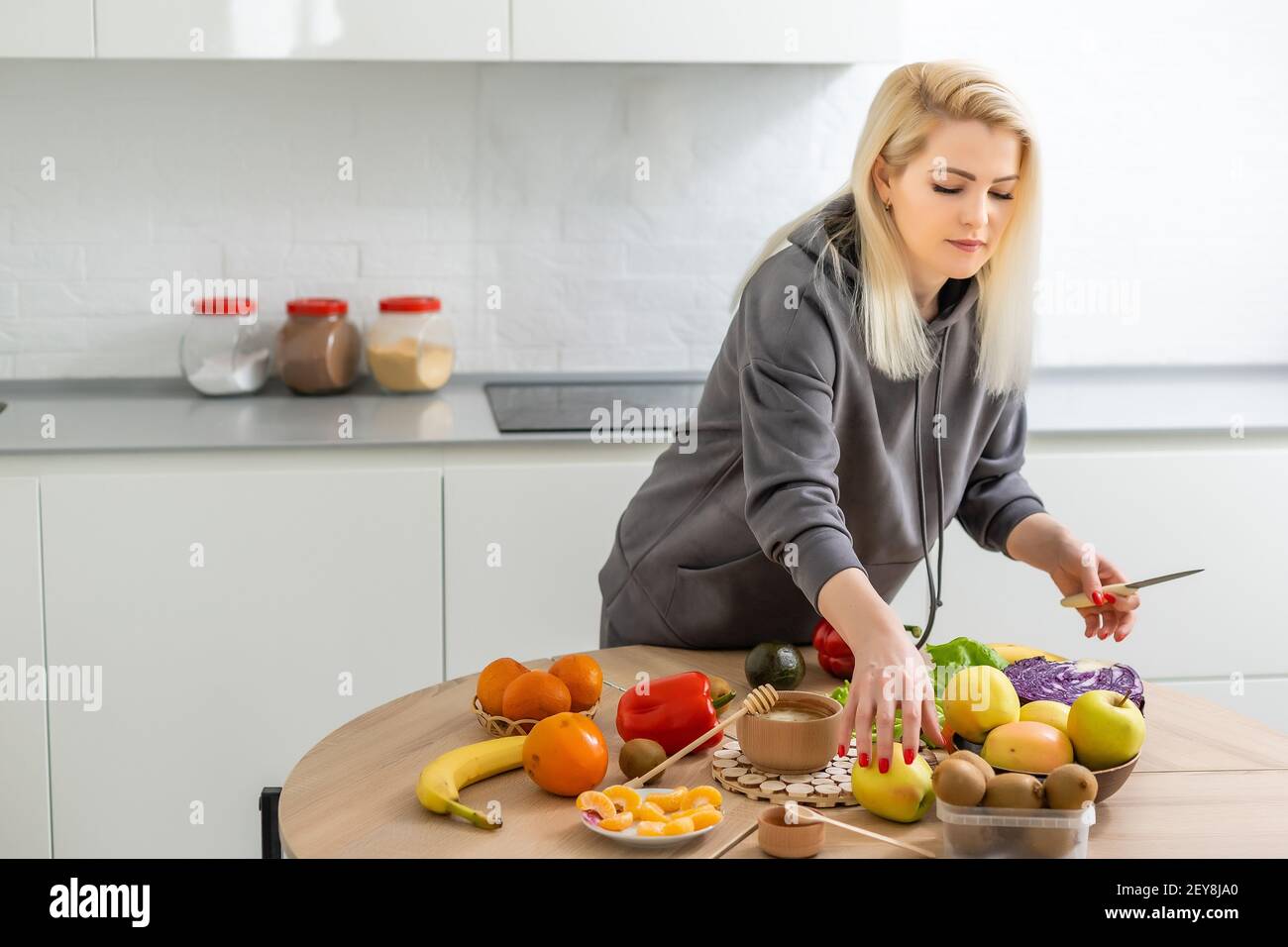Healthy food. Woman preparing fruits and vegetables Stock Photo - Alamy