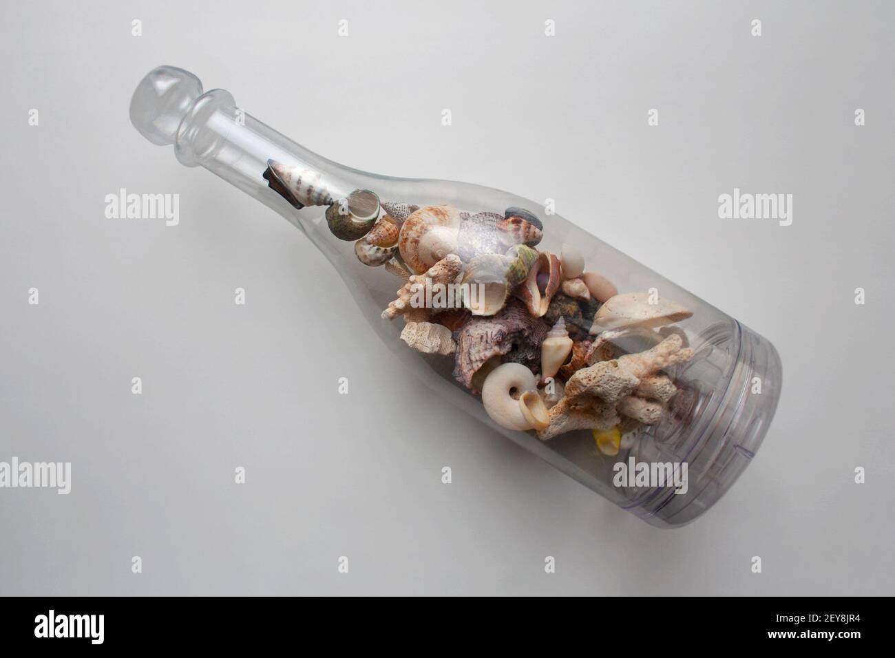 Collection of various seashells inside bottle container isolated on ...