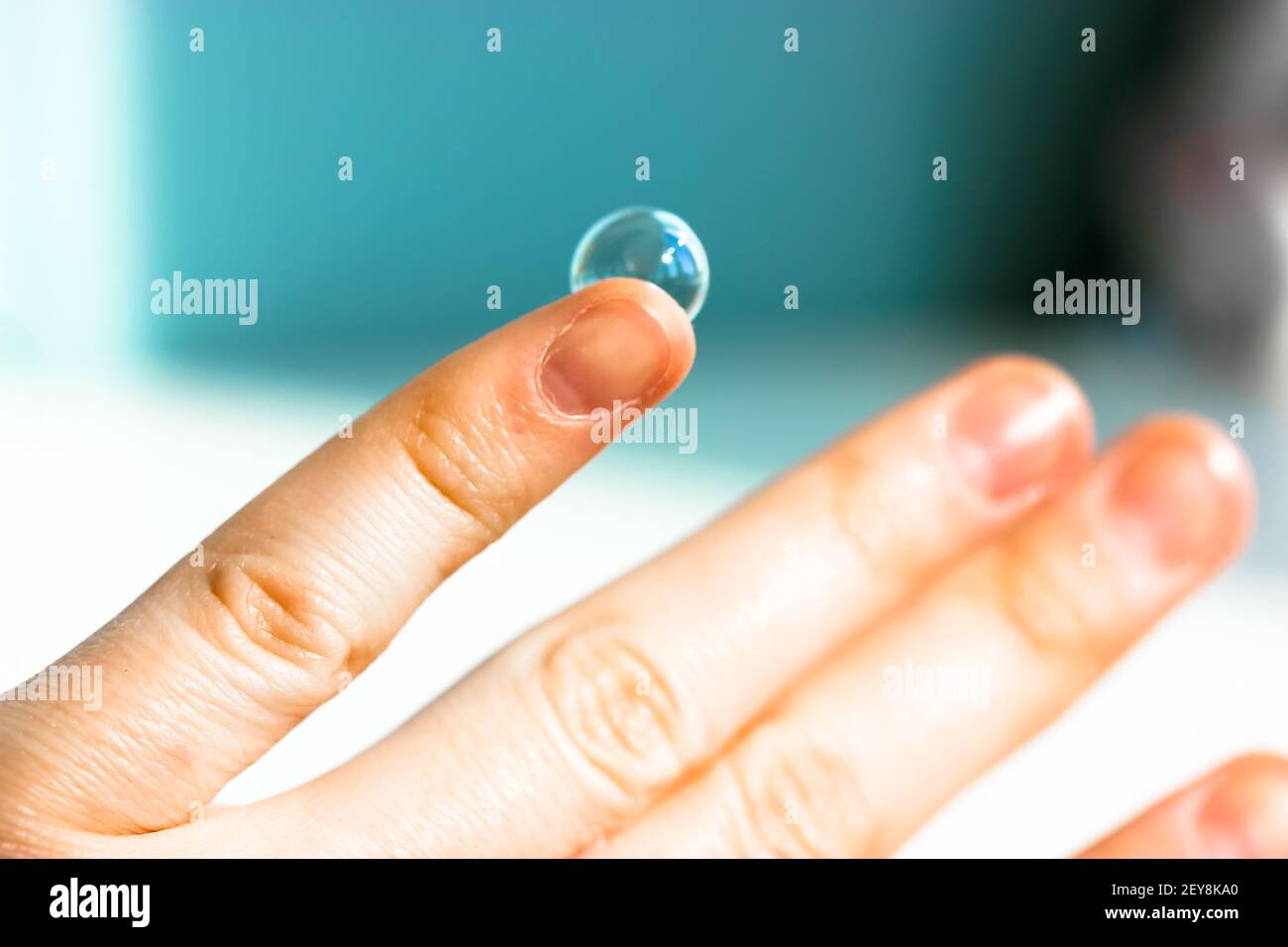 Soap bubble at the tip of the finger of a child's hand. Kids' games and ...