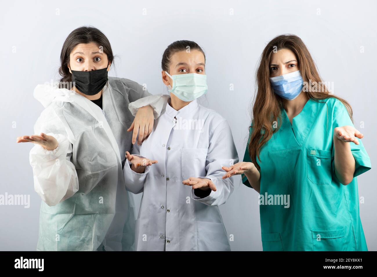 Three young female doctors standing and looking at camera Stock Photo ...