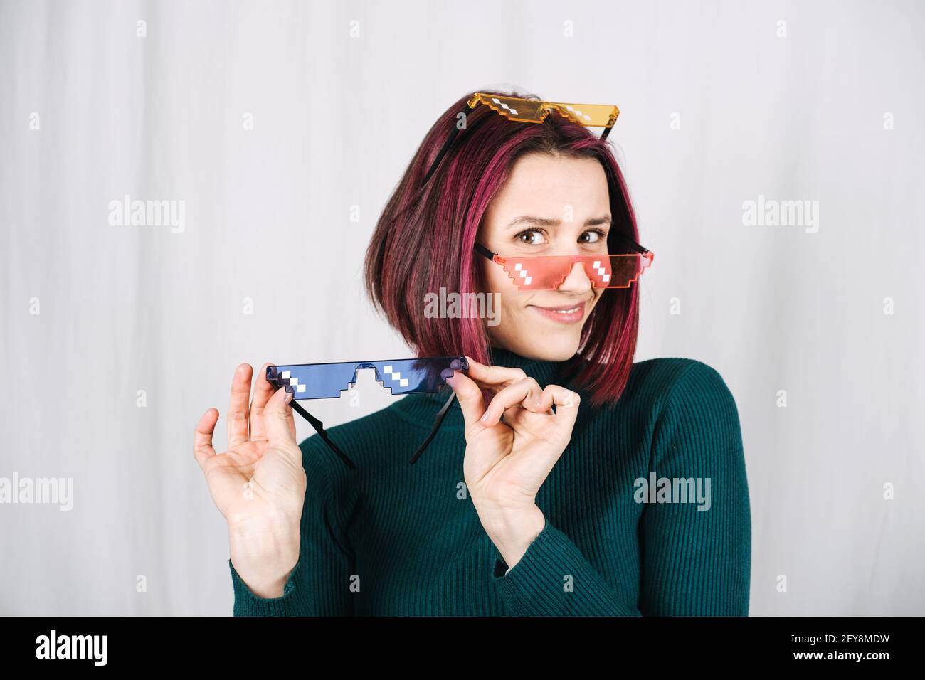 Funny Woman Trying Many Color Pixel Eyeglasses. Young Happy girl with ...