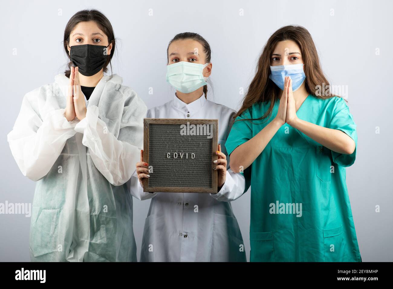 Three young female doctors standing and looking at camera Stock Photo ...