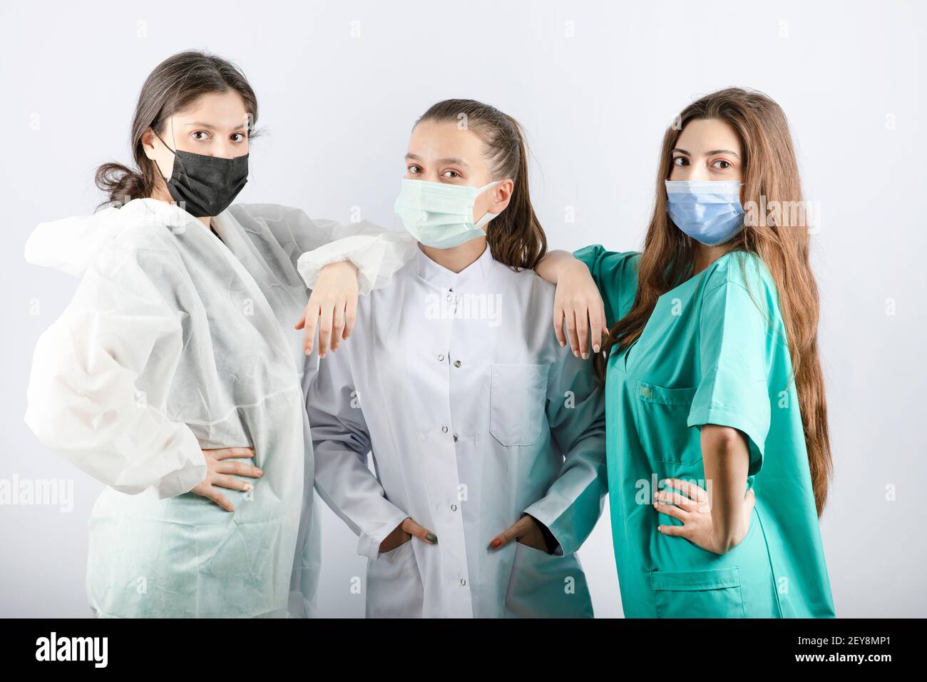 Three young female doctors standing and looking at camera Stock Photo ...