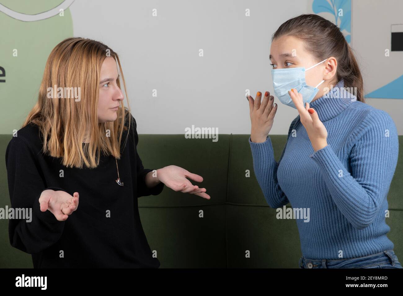 Young blonde girl asking something wrong with her friedn Stock Photo ...