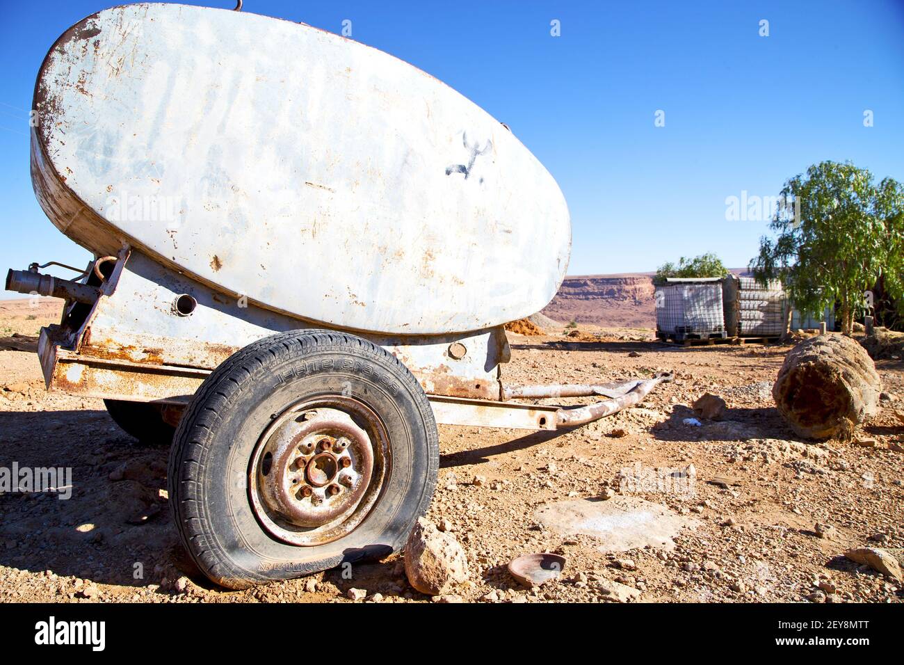 Water tank in tree weel and arid Stock Photo - Alamy