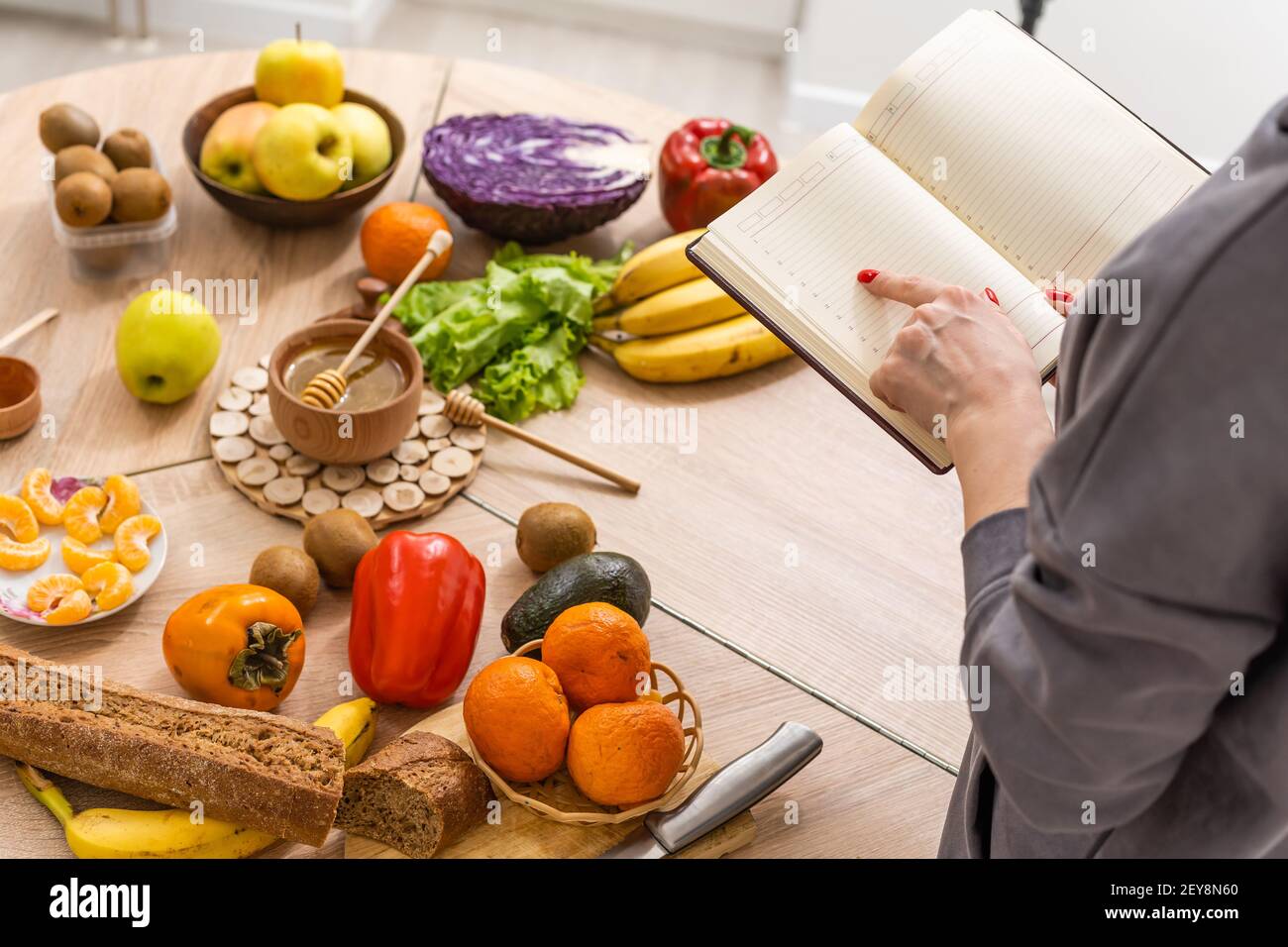 Healthy food. Woman preparing fruits and vegetables Stock Photo - Alamy