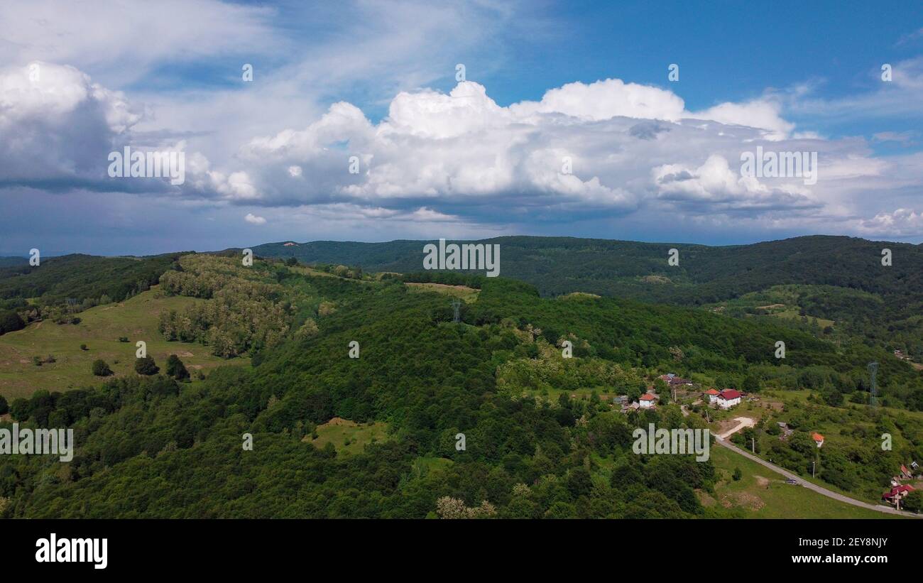 An aerial view of a vast mountainous landscape under a cloudy sky ...