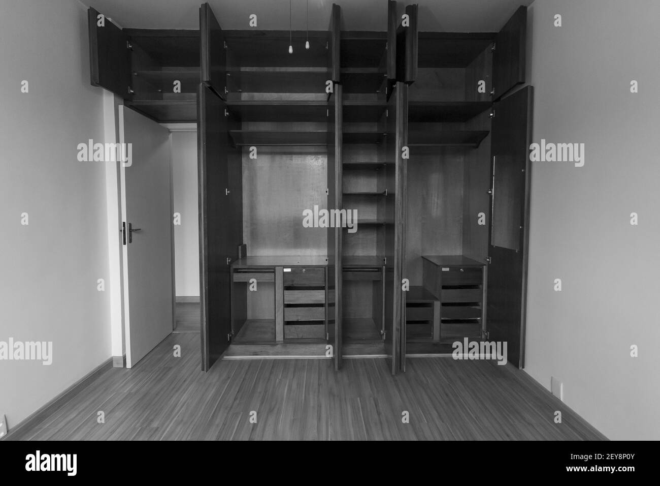 An empty apartment room interior with a black open empty closet Stock ...