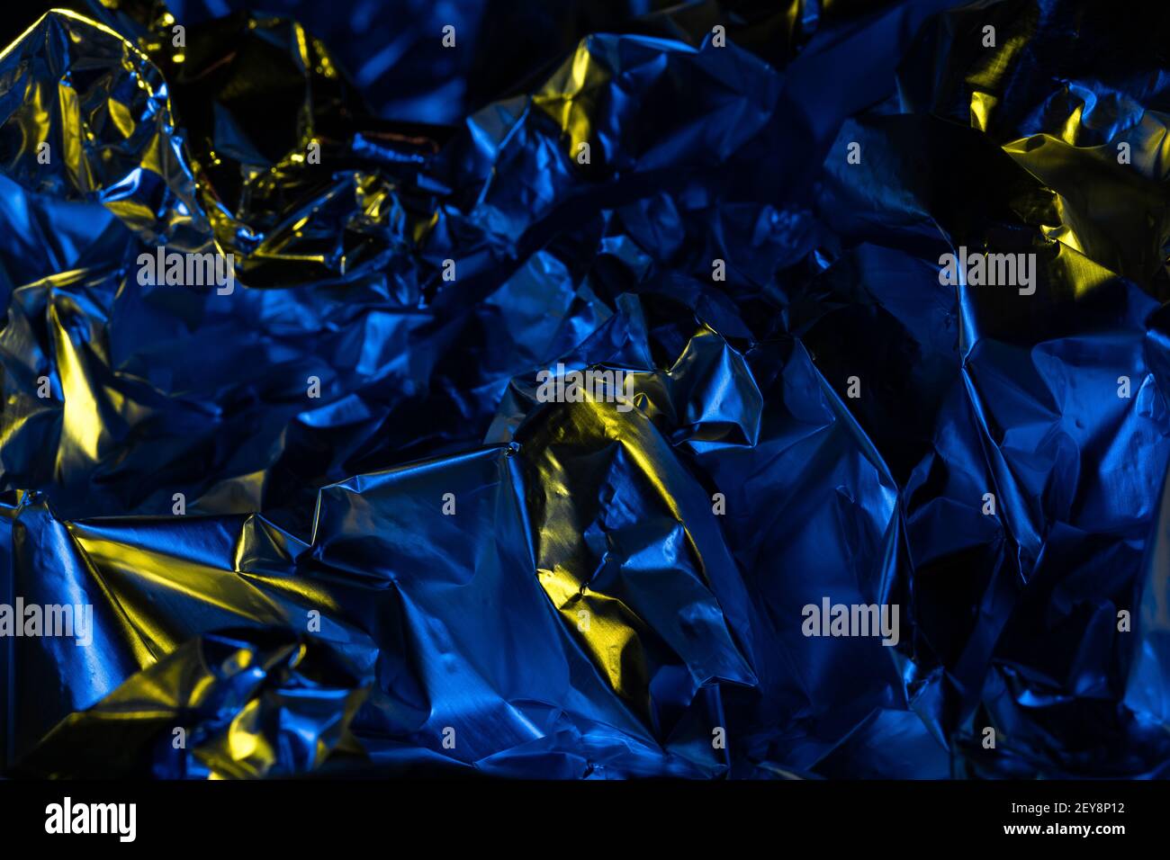 A crumpled colorful metal foil texture background Stock Photo - Alamy