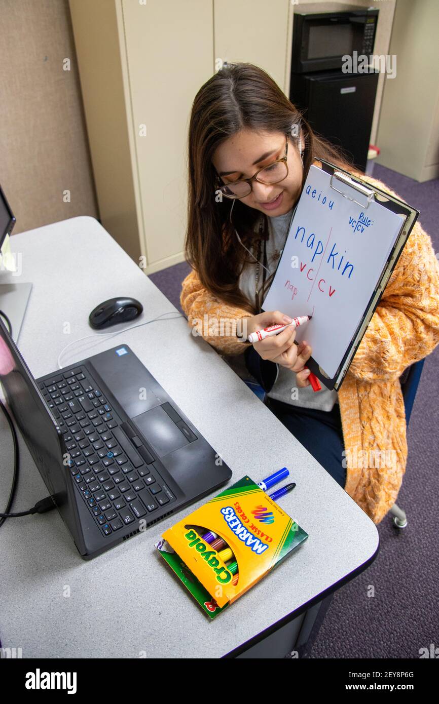 Holding Up A Written Sheet Of The Two syllable Word napkin A holding-up-a-written-sheet-of-the-two-syllable-word-napkin-a