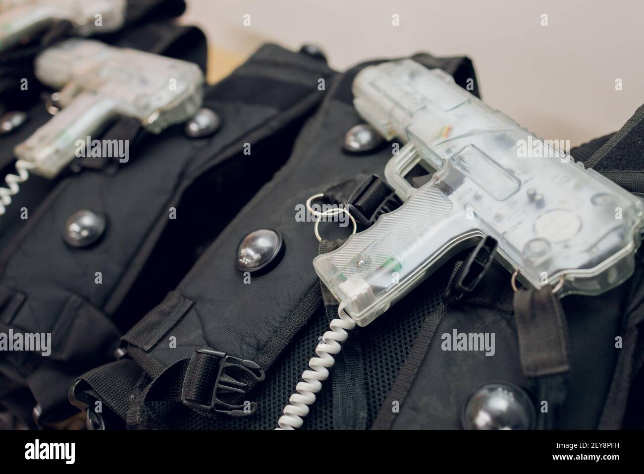 Weapons close-up on a military man standing inside the building and ...