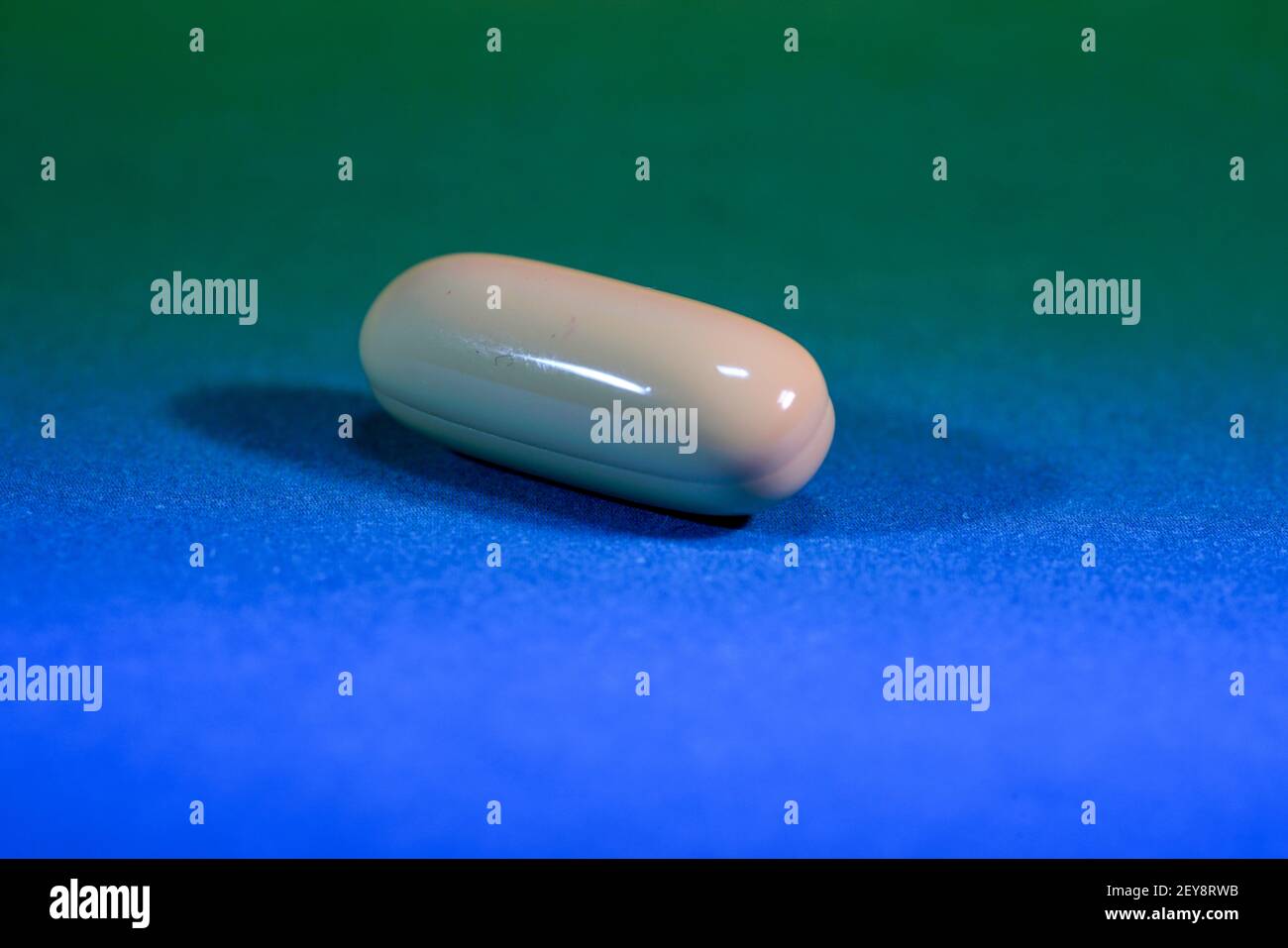 A white capsule isolated on a gradient backgro Stock Photo - Alamy