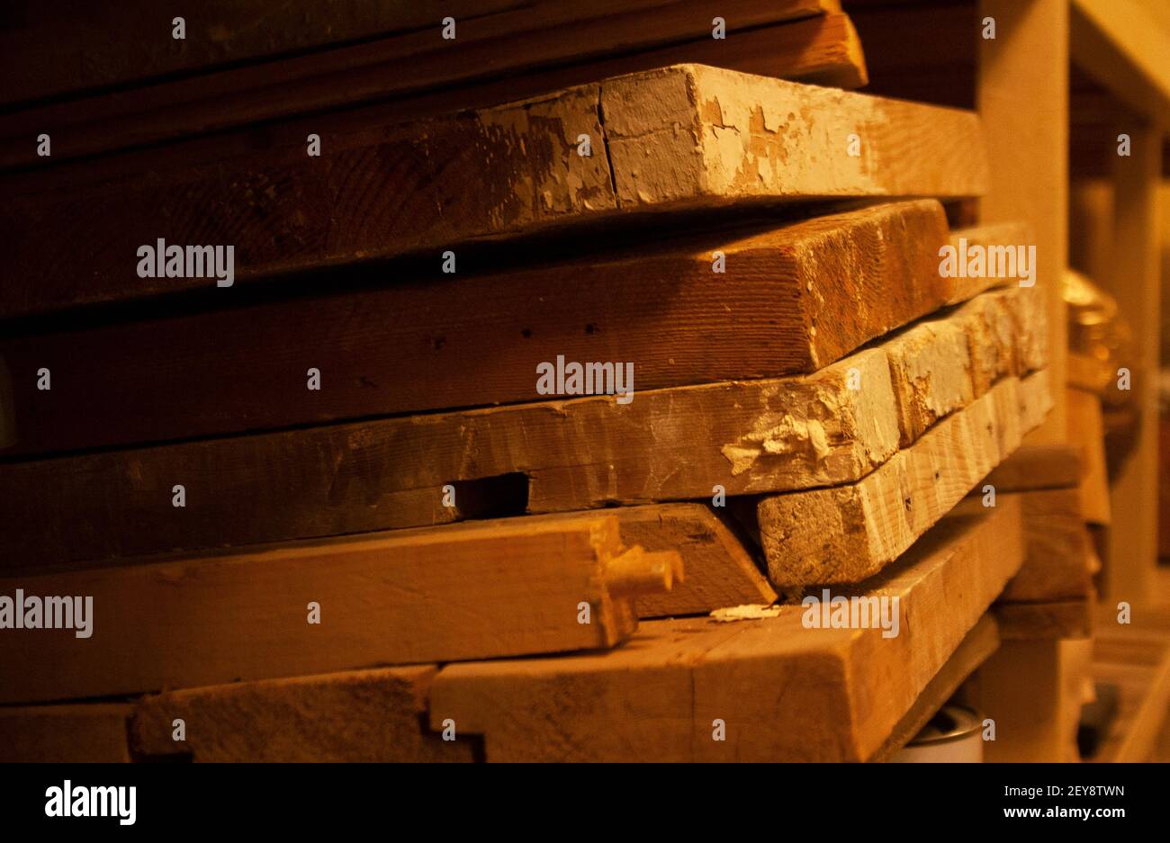 Workshop stand shelving with stack of textured wooden frames and ...