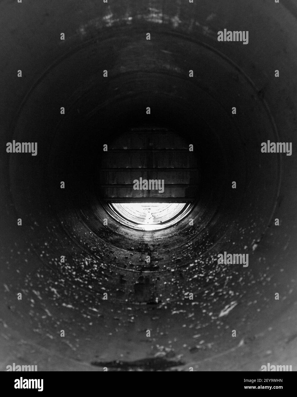 A vertical greyscale shot of the inside of a dirty pipe Stock Photo - Alamy