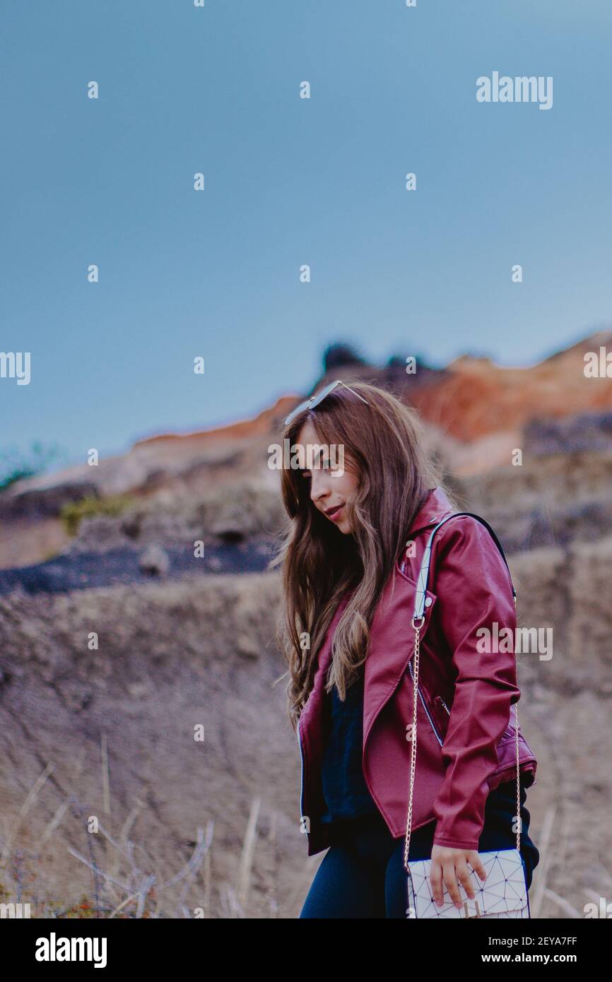 A vertical shot of a stylish lady wearing a red lea in the Sabrinsky ...