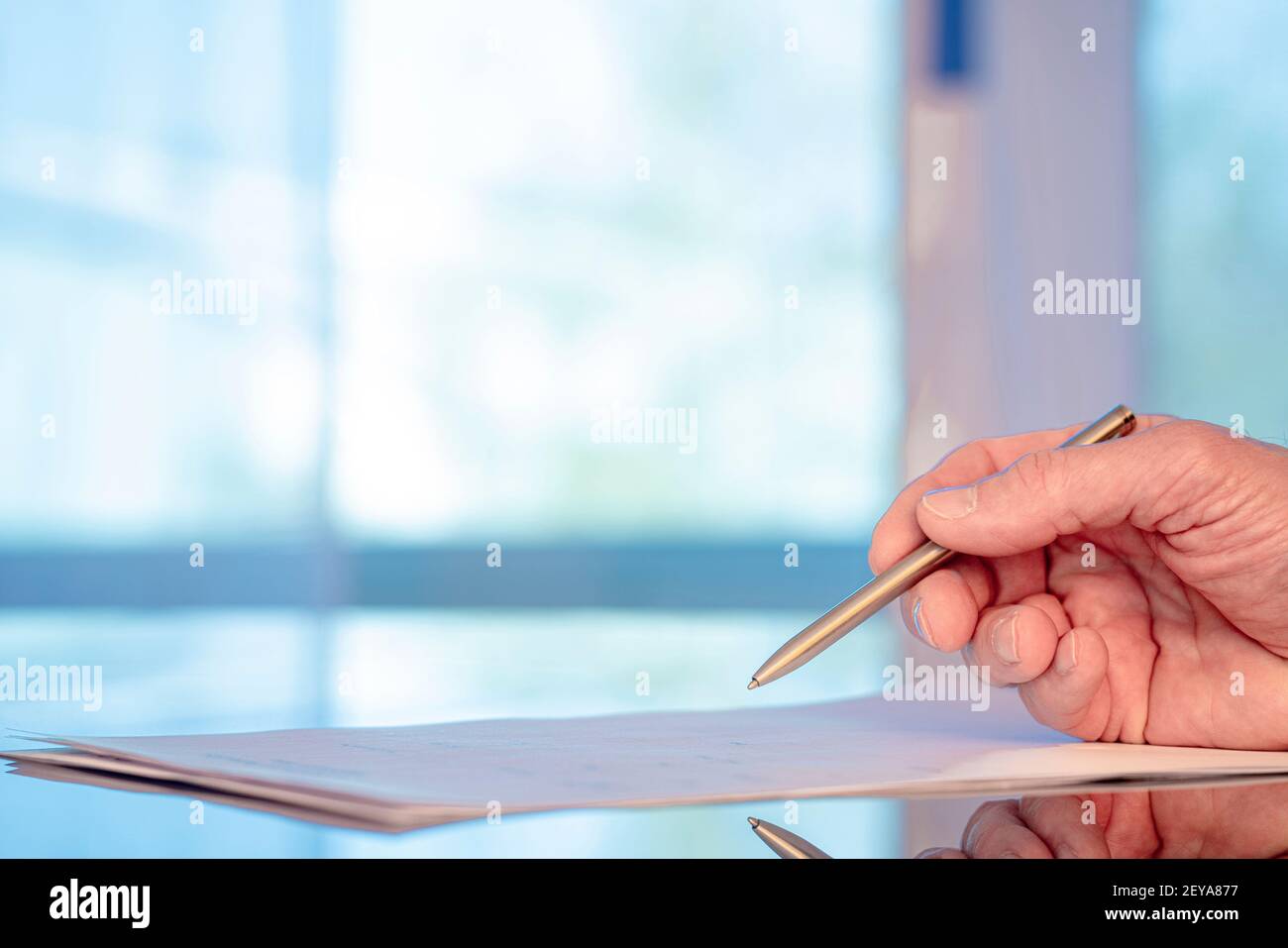 Man signing document Stock Photo - Alamy