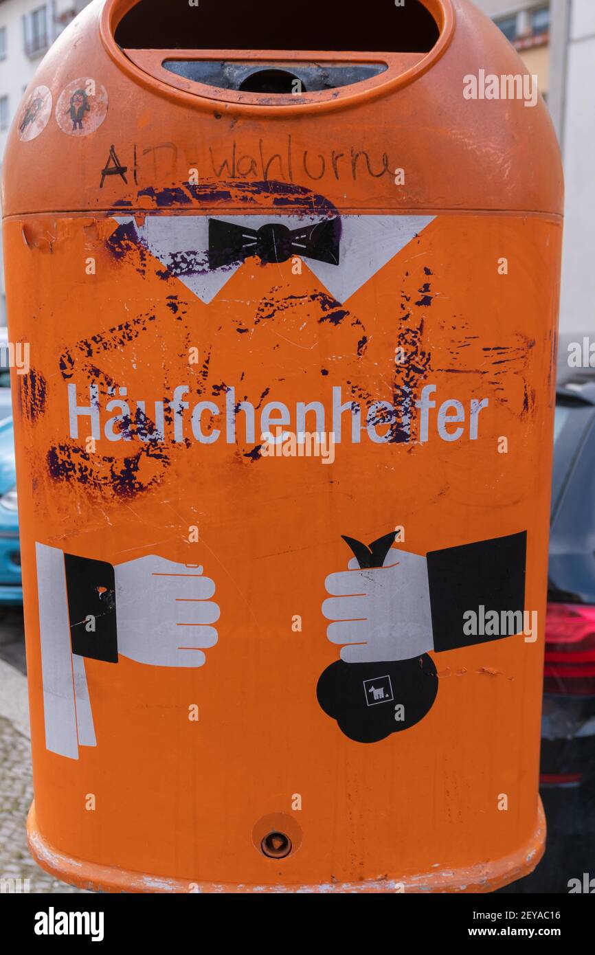 A vertical shot of an orange dirty trash bin Stock Photo - Alamy