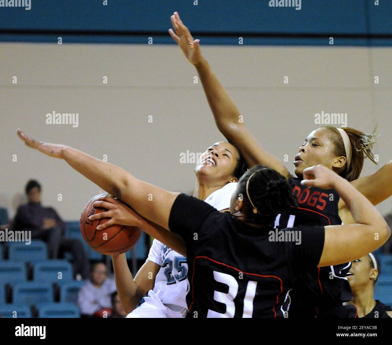 Coastal Carolina's Alexx Puckett, left, is fouled by Gardner-Webb's ...