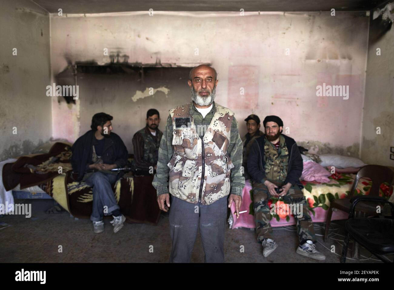 A FSA fighter poses for a portrait along the front line of Sheikh Said ...