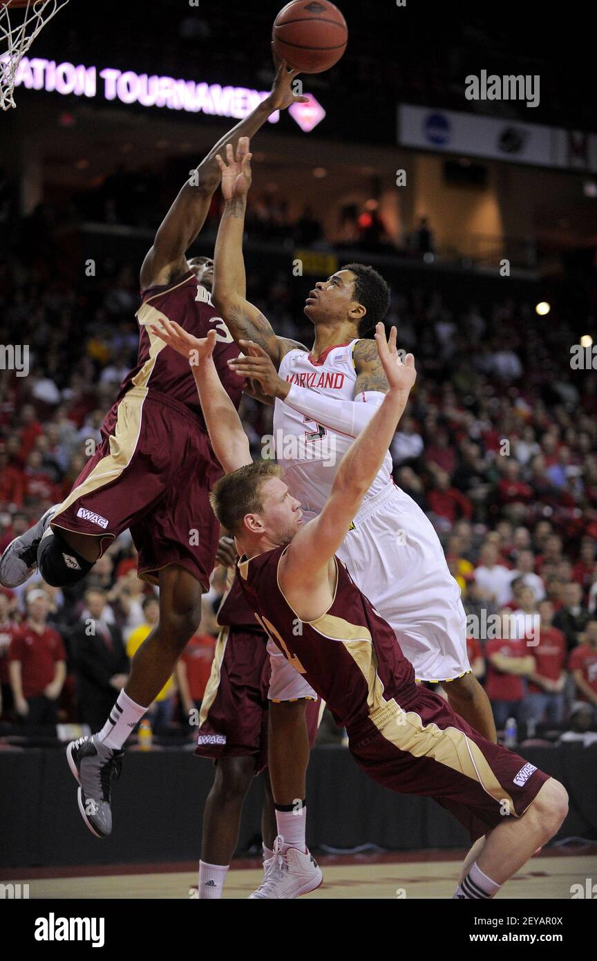 Maryland's Nick Faust cannot get his shot past Denver defenders Chris ...