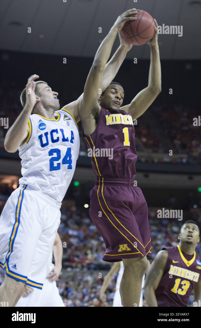 Travis Wear (24) of UCLA and Andre Hollins (1) of Minnesota battle for ...