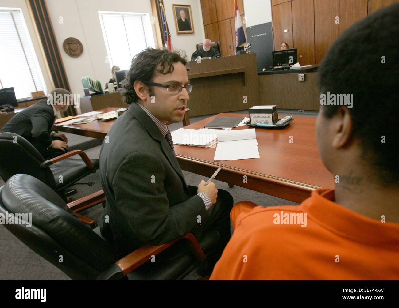 Attorney Curt Winegarner talks on the phone while surrounded by his ...