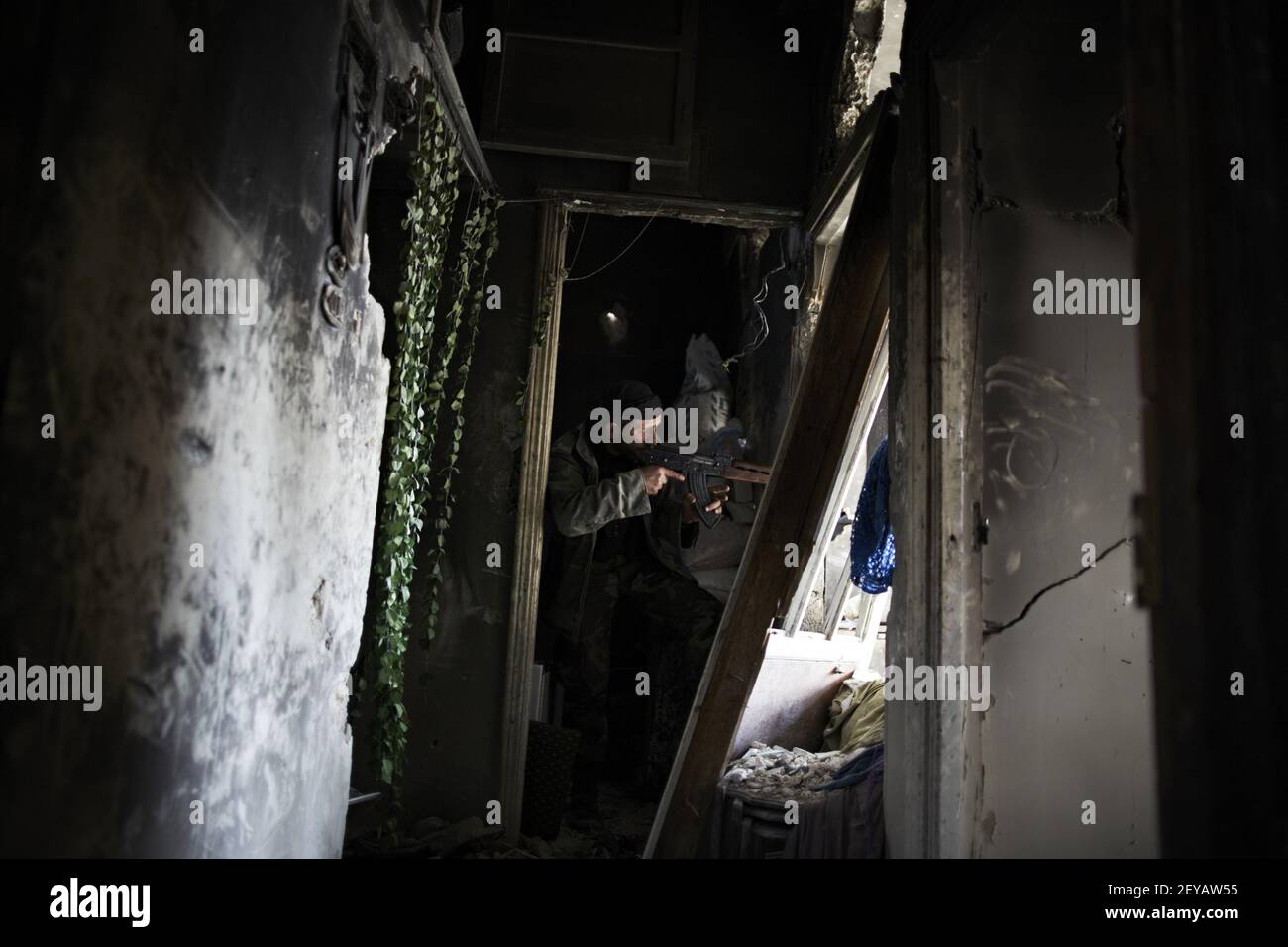 A FSA fighter holds his position in a building along one of Aleppo's ...