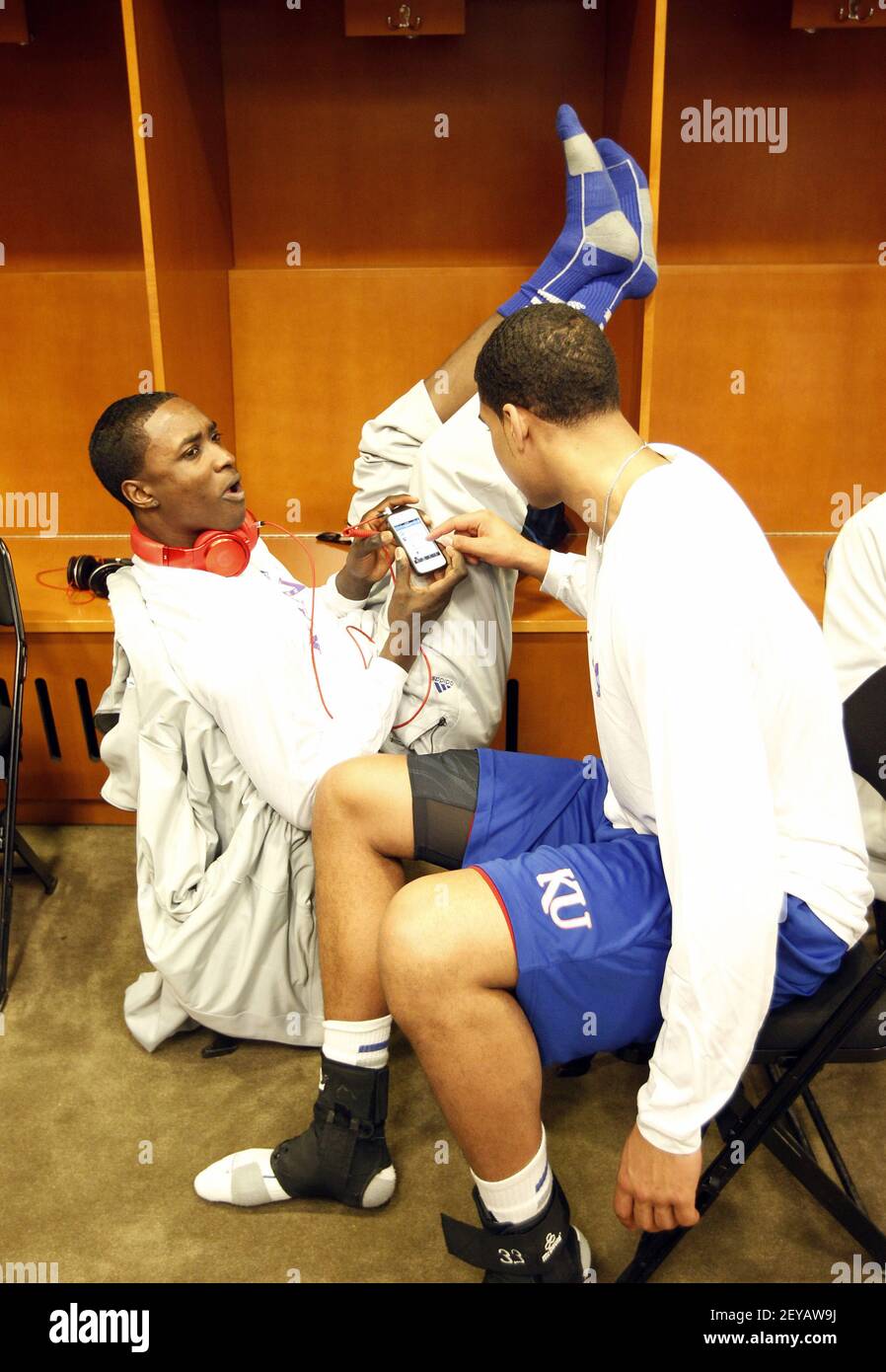 Kansas guard Rio Adams, left, relaxes with his feet up, as Kansas ...