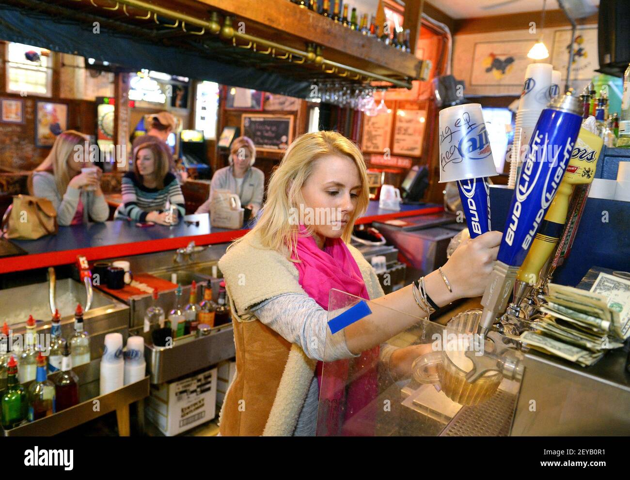 University of Kansas senior Colleen Monaghan tends bar at The Wheel ...