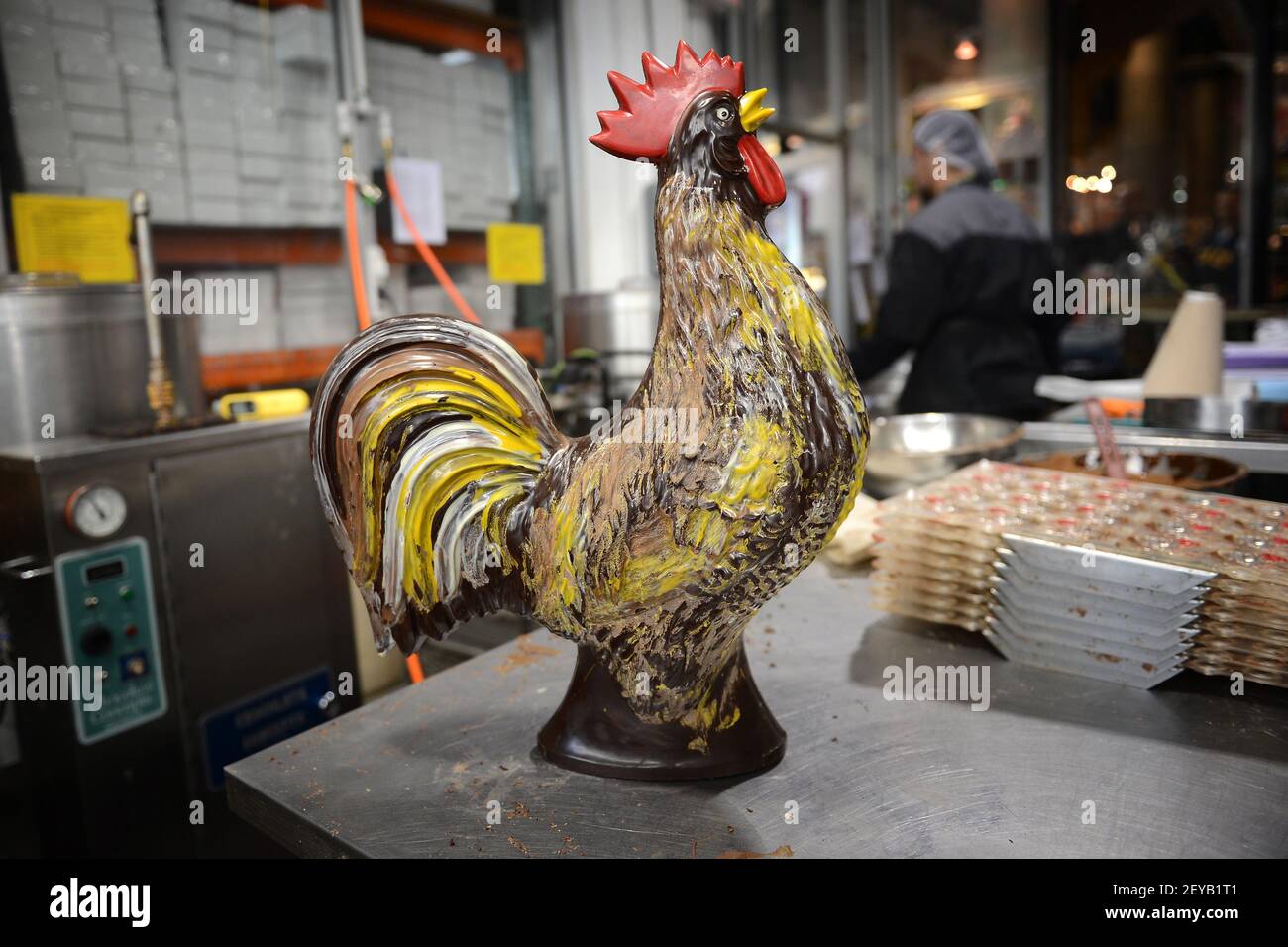 A nearly one foot tall chocolate rooster rests on the production table ...