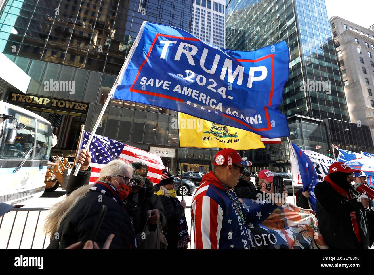 Trump supporters march towards Times Square holding up Trump and ...