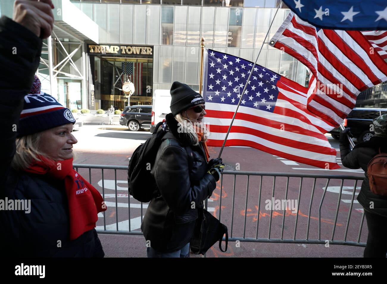 Trump supporters march towards Times Square holding up Trump and ...