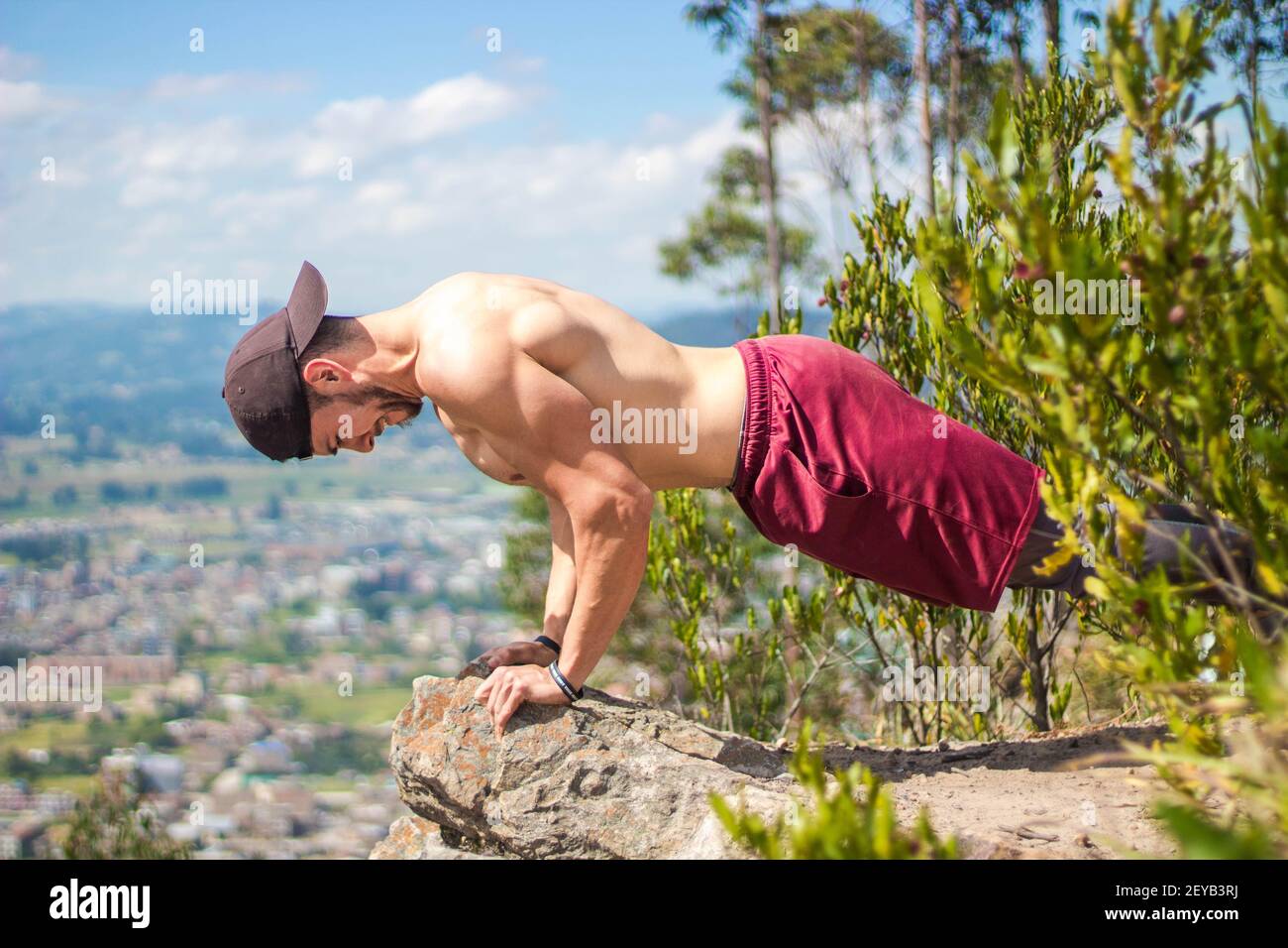 An athletic sportsman doing push up exercises in nature Stock Photo - Alamy