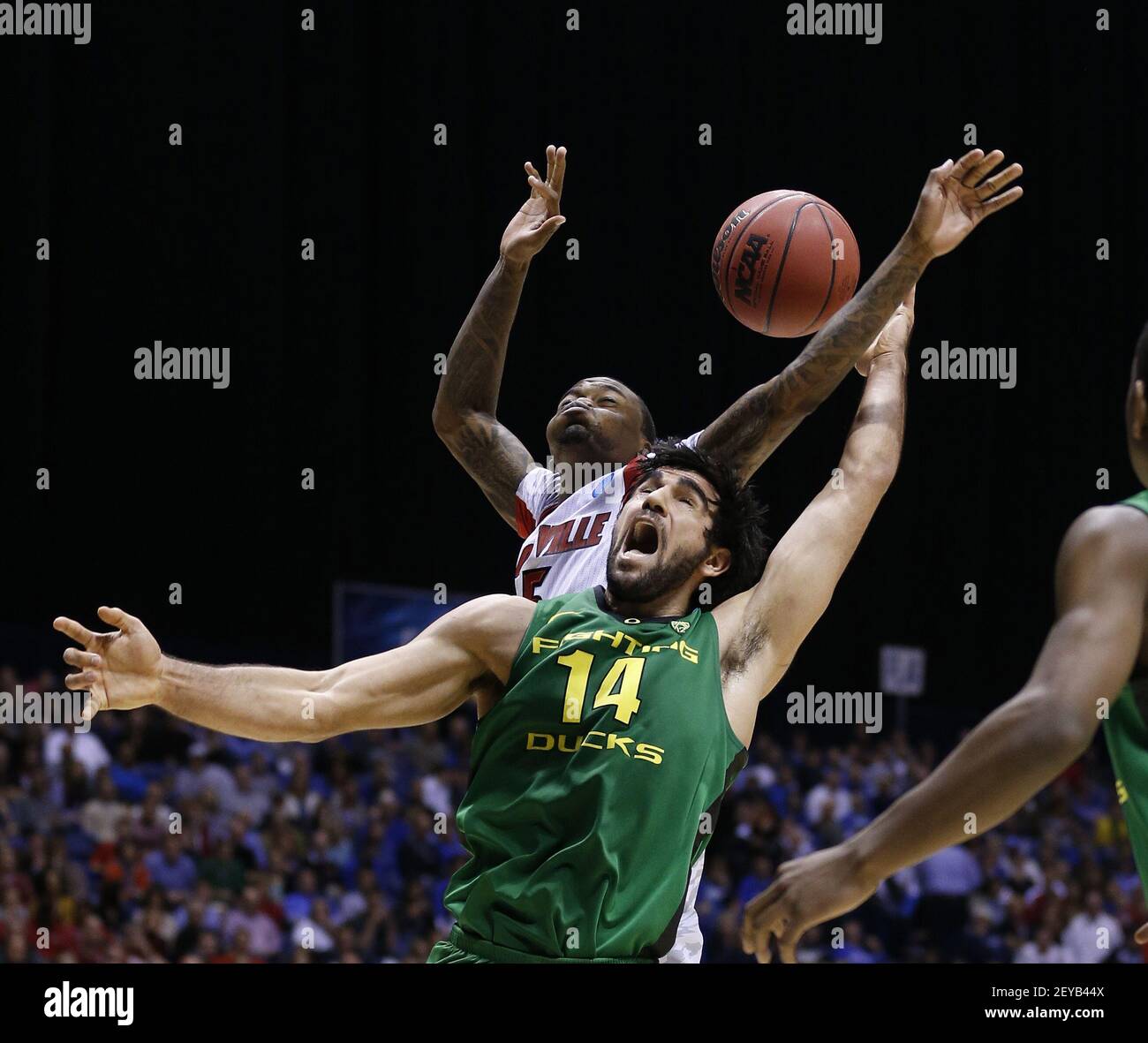 Louisville guard Kevin Ware (5) blocks Oregon forward Arsalan Kazemi ...