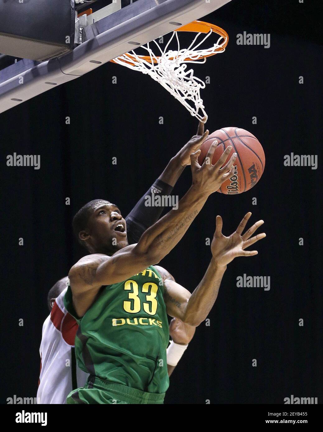 Oregon forward Carlos Emory (33) is blocked in first half action in ...