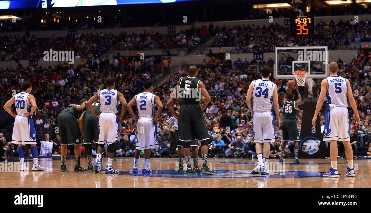 Players from both teams watch as Michigan State forward Derrick Nix (25 ...