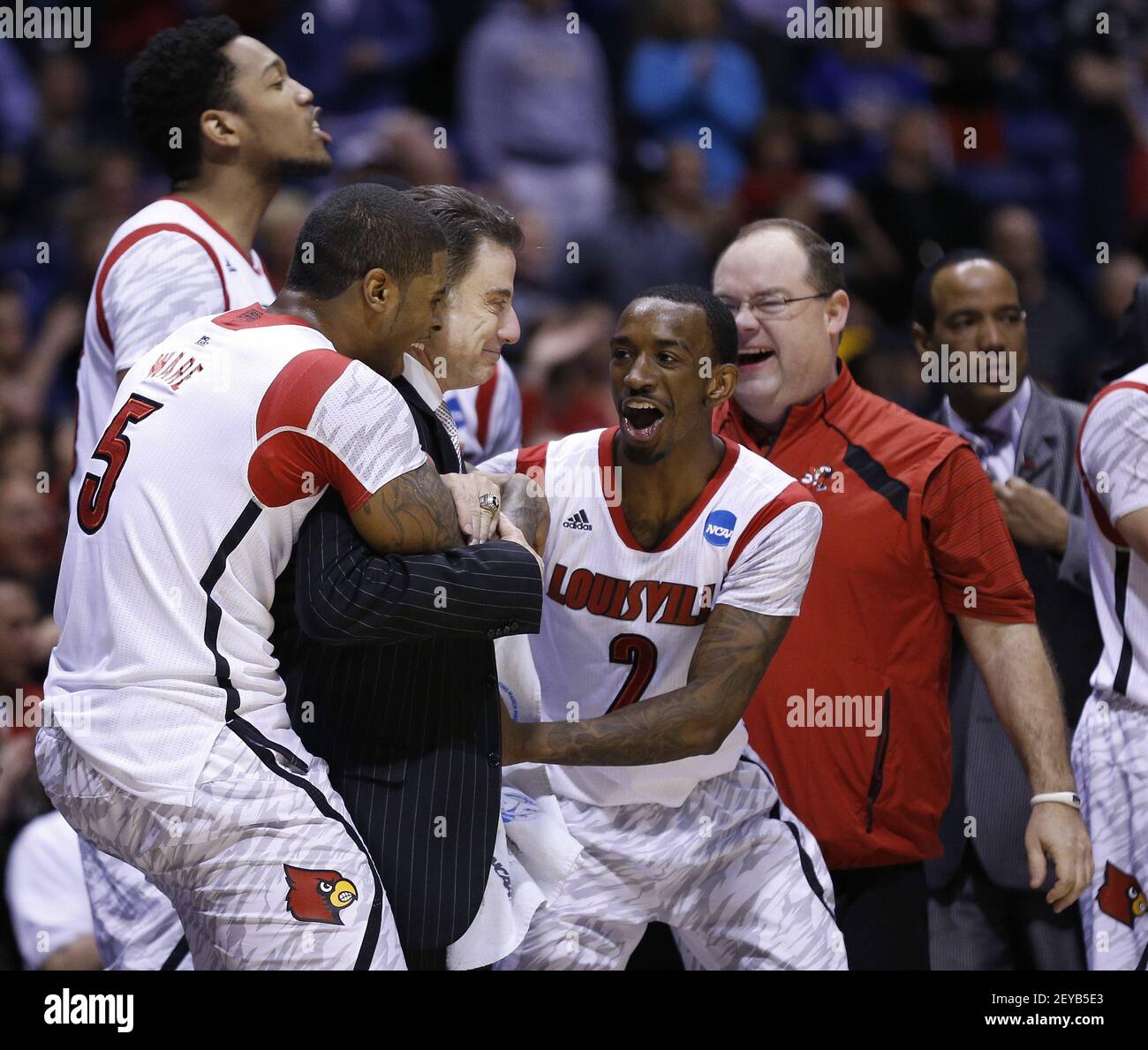 Louisville head coach Rick Pitino is embraced by his team, including ...
