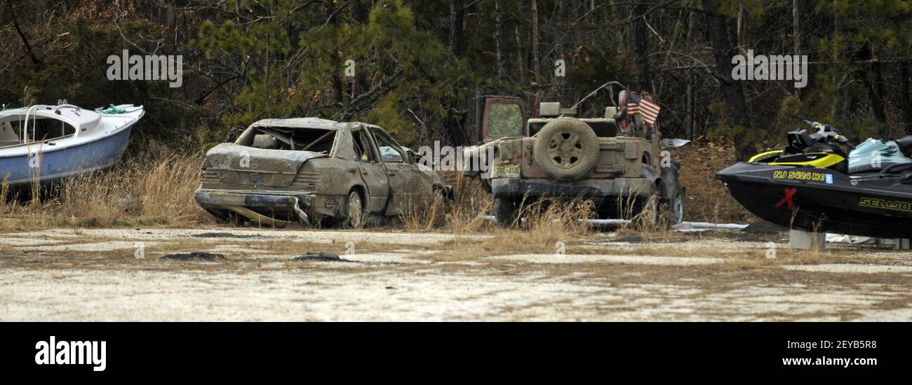 At a fenced compound in Brick, New Jersey, hulks of ruined vehicles ...