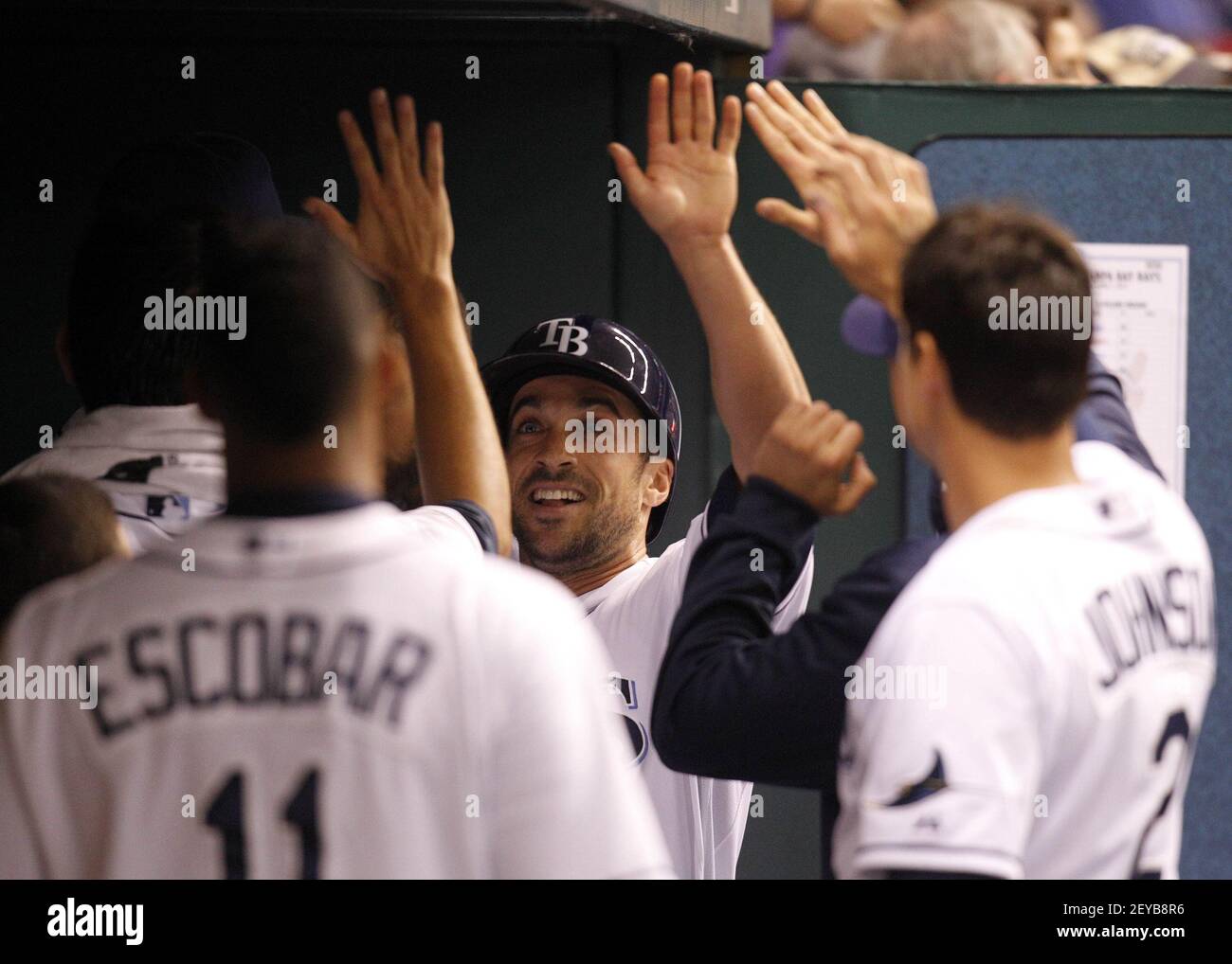 Tampa Bay Rays left fielder Sam Fuld is congratulated after scoring in ...