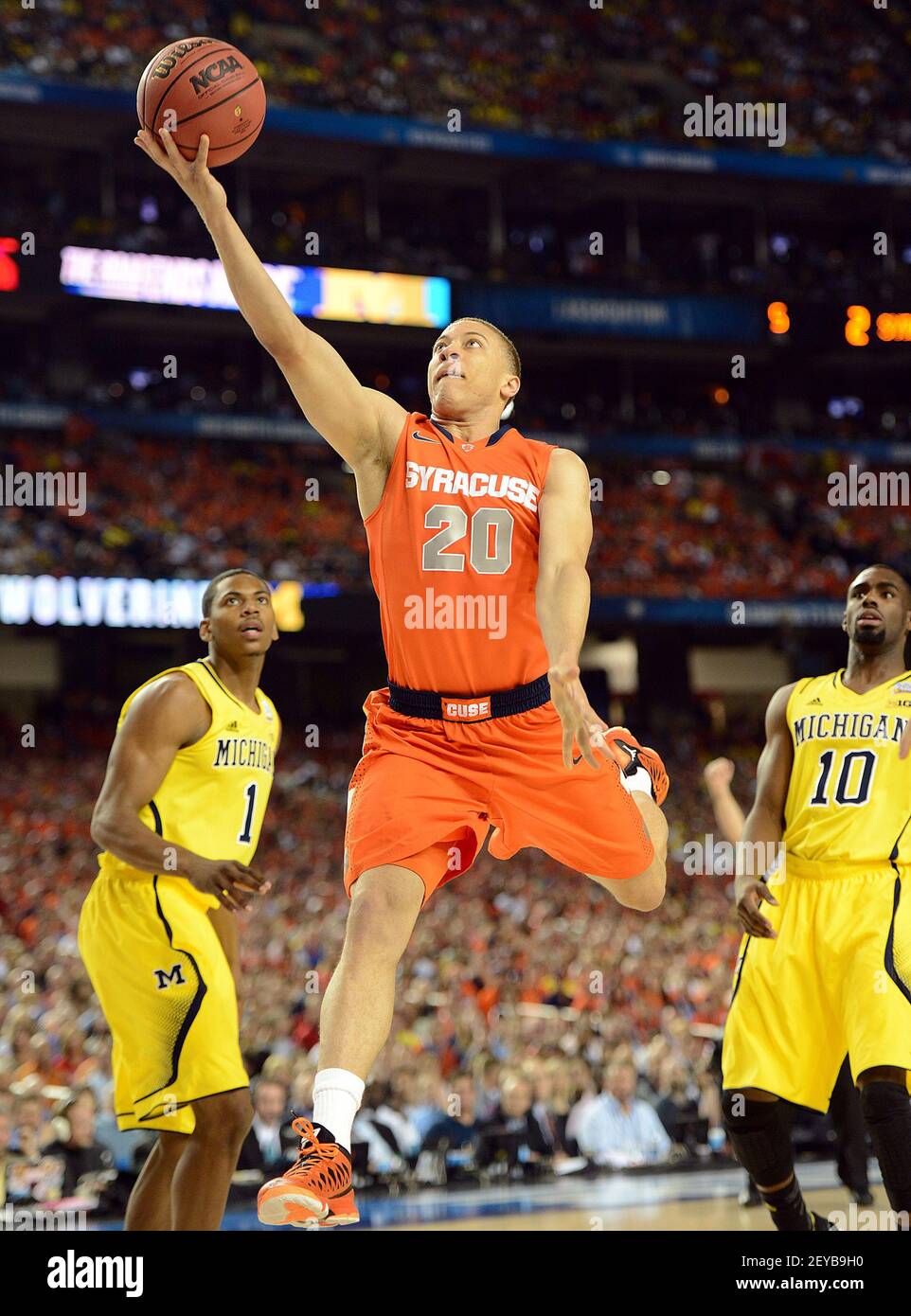 Syracuse guard Brandon Triche gets past Michigan defenders Glenn ...