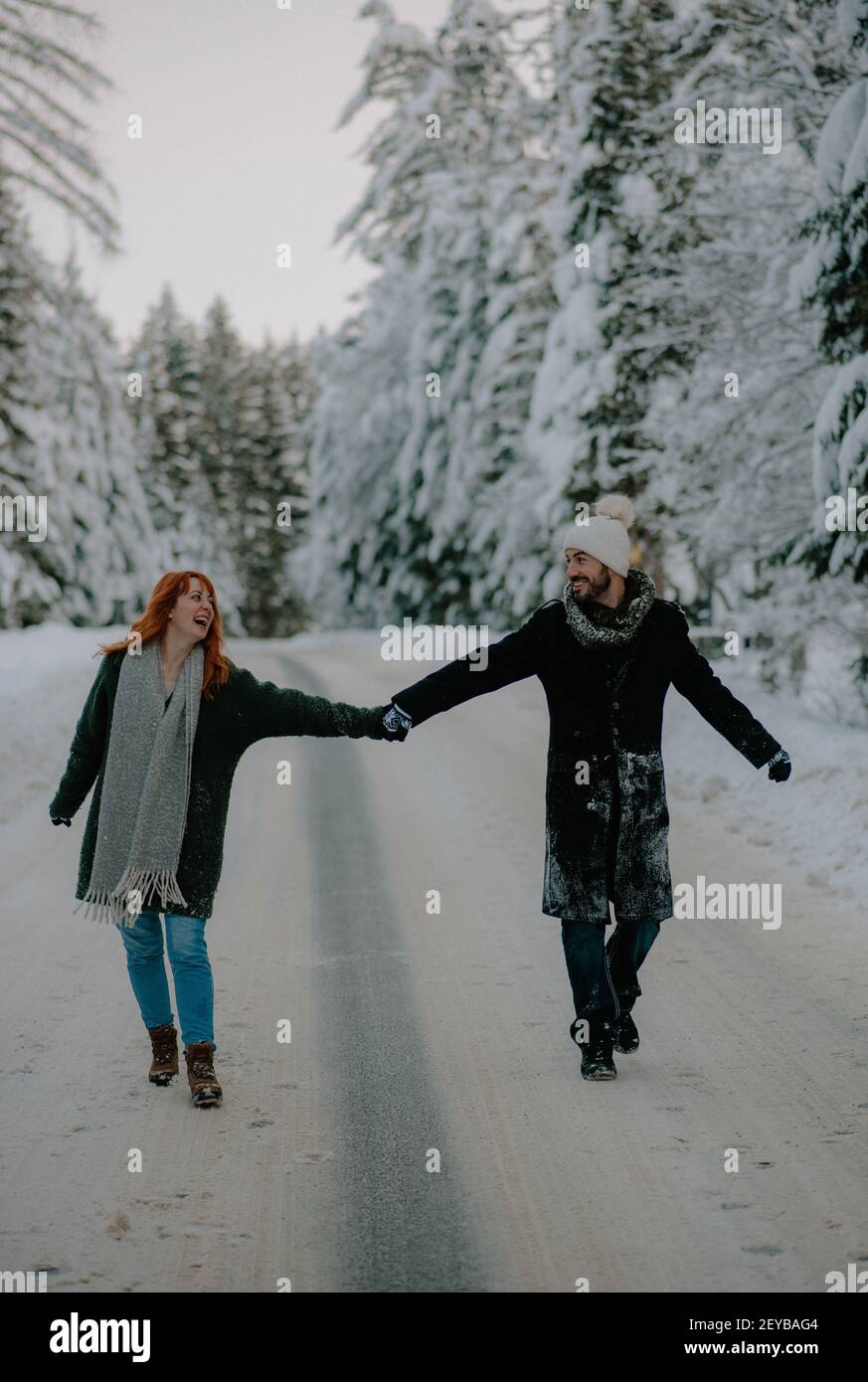 A beautiful loving couple holding hands and looking at each other with ...