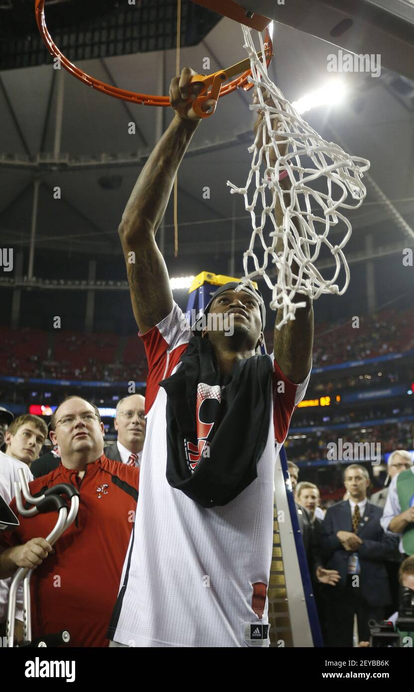 Louisville's Kevin Ware cuts the net after Louisville defeated Michigan ...