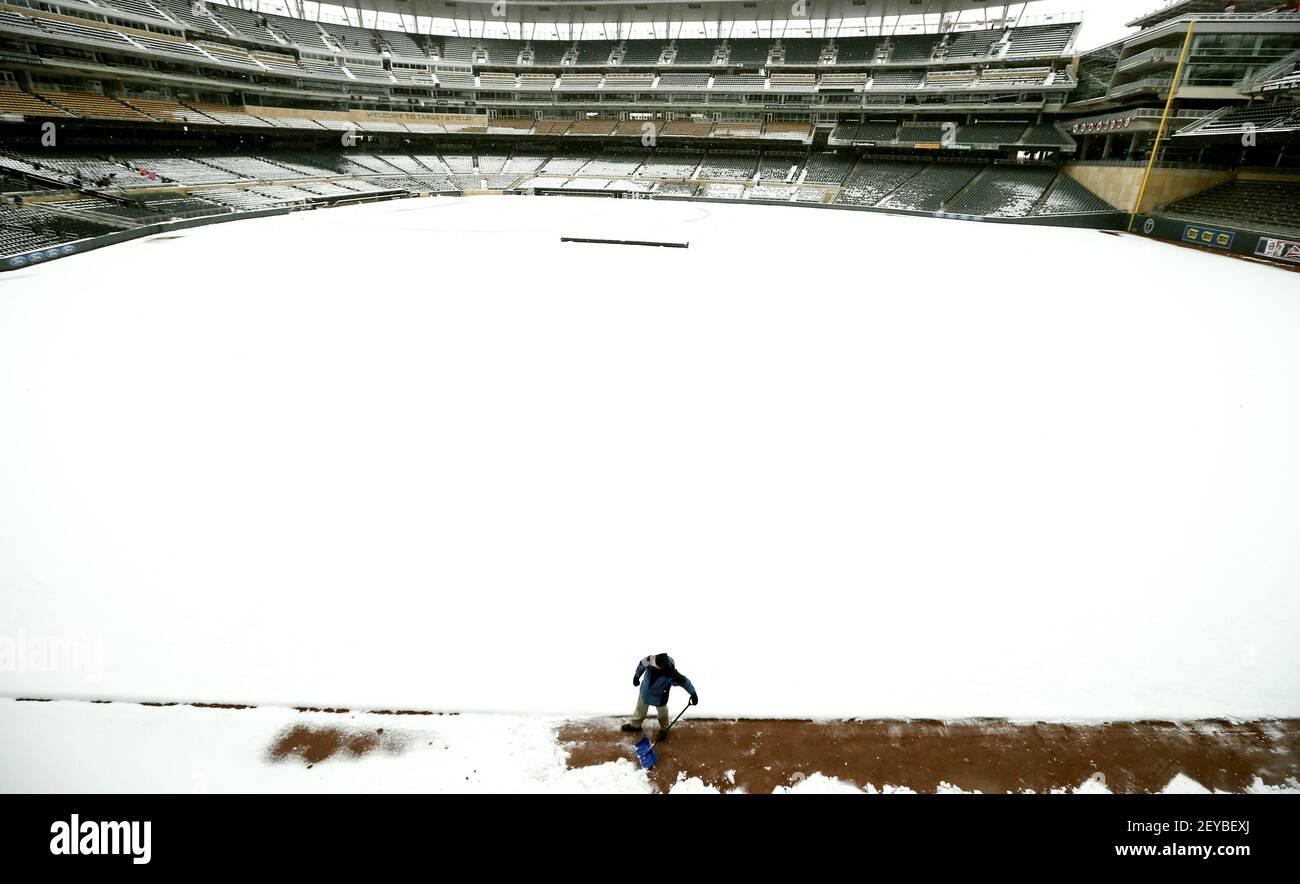 Target Field grounds keeper Larry Divito removes snow on the warning ...